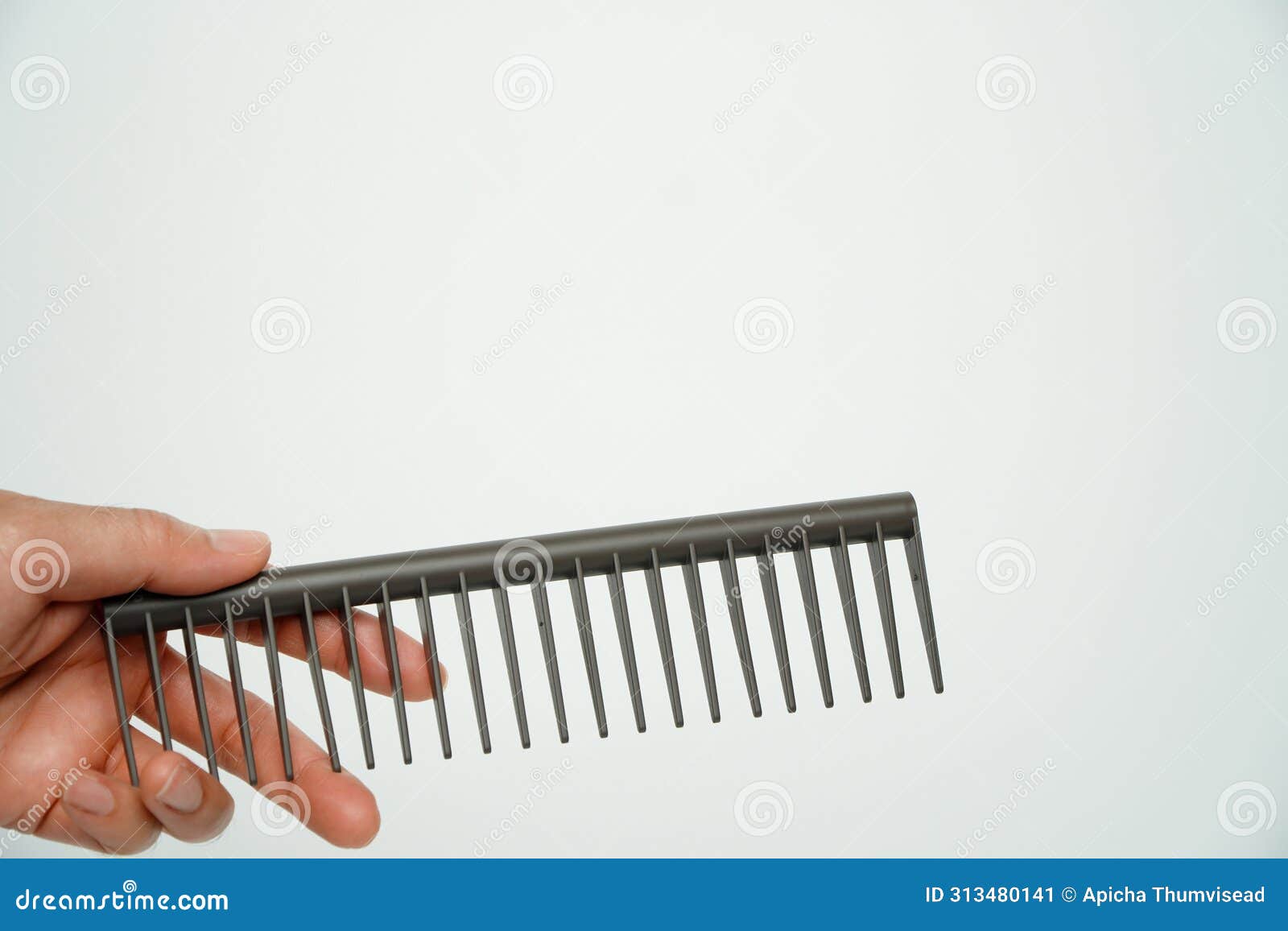 Human Hand Holding a Comb on White Background Isolation Stock Image ...