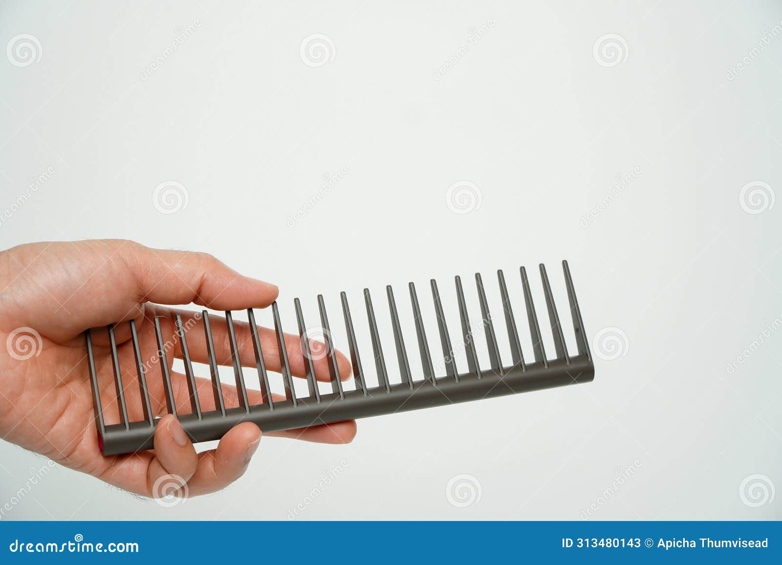 Human Hand Holding a Comb on White Background Isolation Stock Image ...