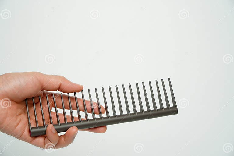 Human Hand Holding a Comb on White Background Isolation Stock Image ...