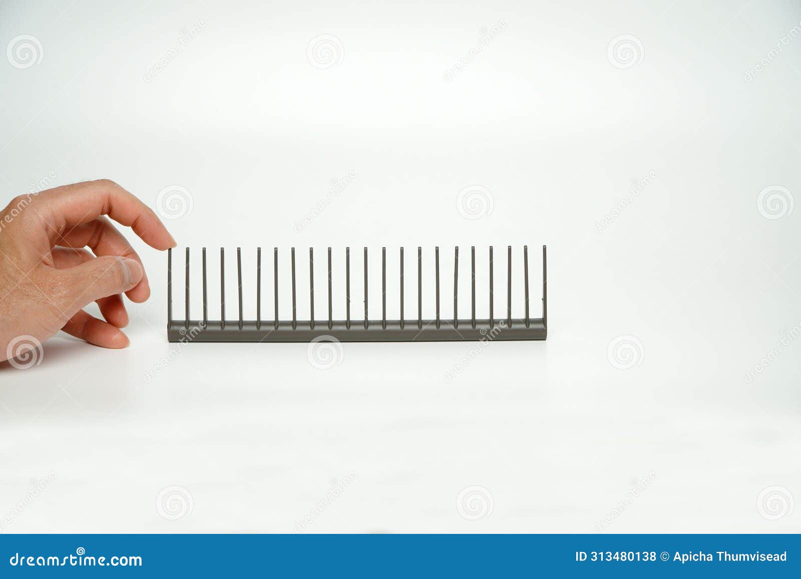 Human Hand Holding a Comb on White Background Isolation Stock Photo ...