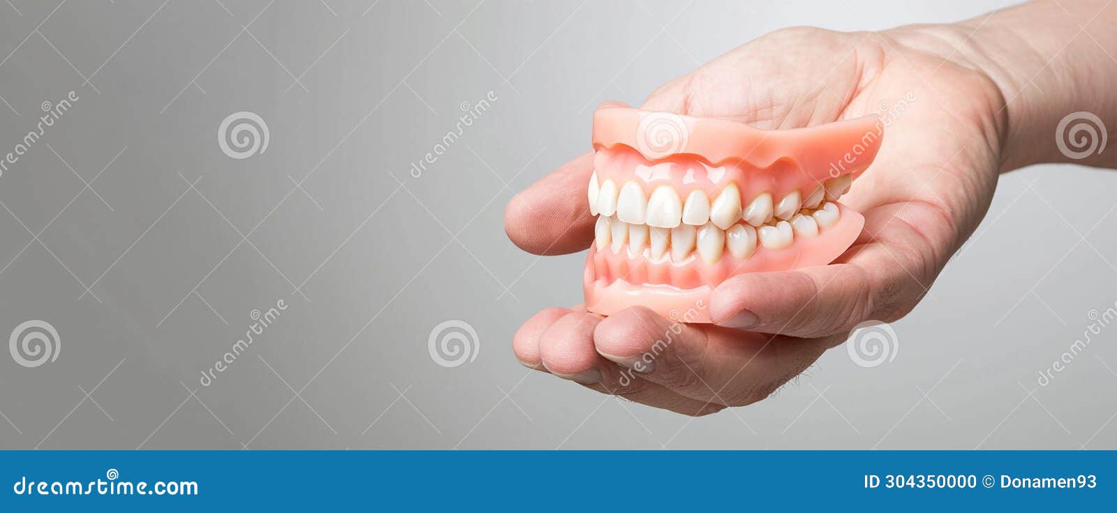 Human Hand Holding Complete Upper and Lower Denture Set on Neutral ...