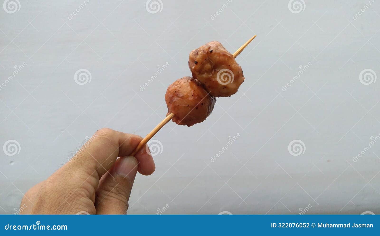 Human Hand Holding a Meatball Skewer on a White Background Stock Photo ...