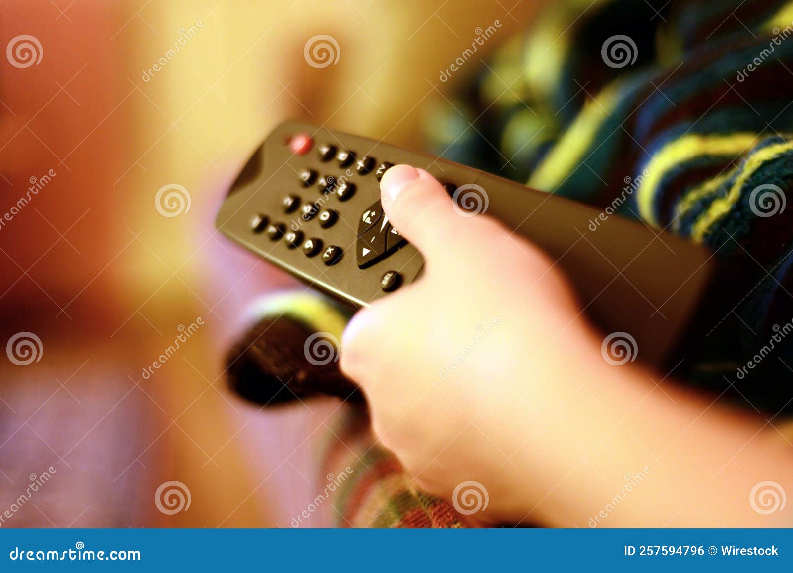 Human Hand Holding Remote Control in Blurred Background Stock Photo ...