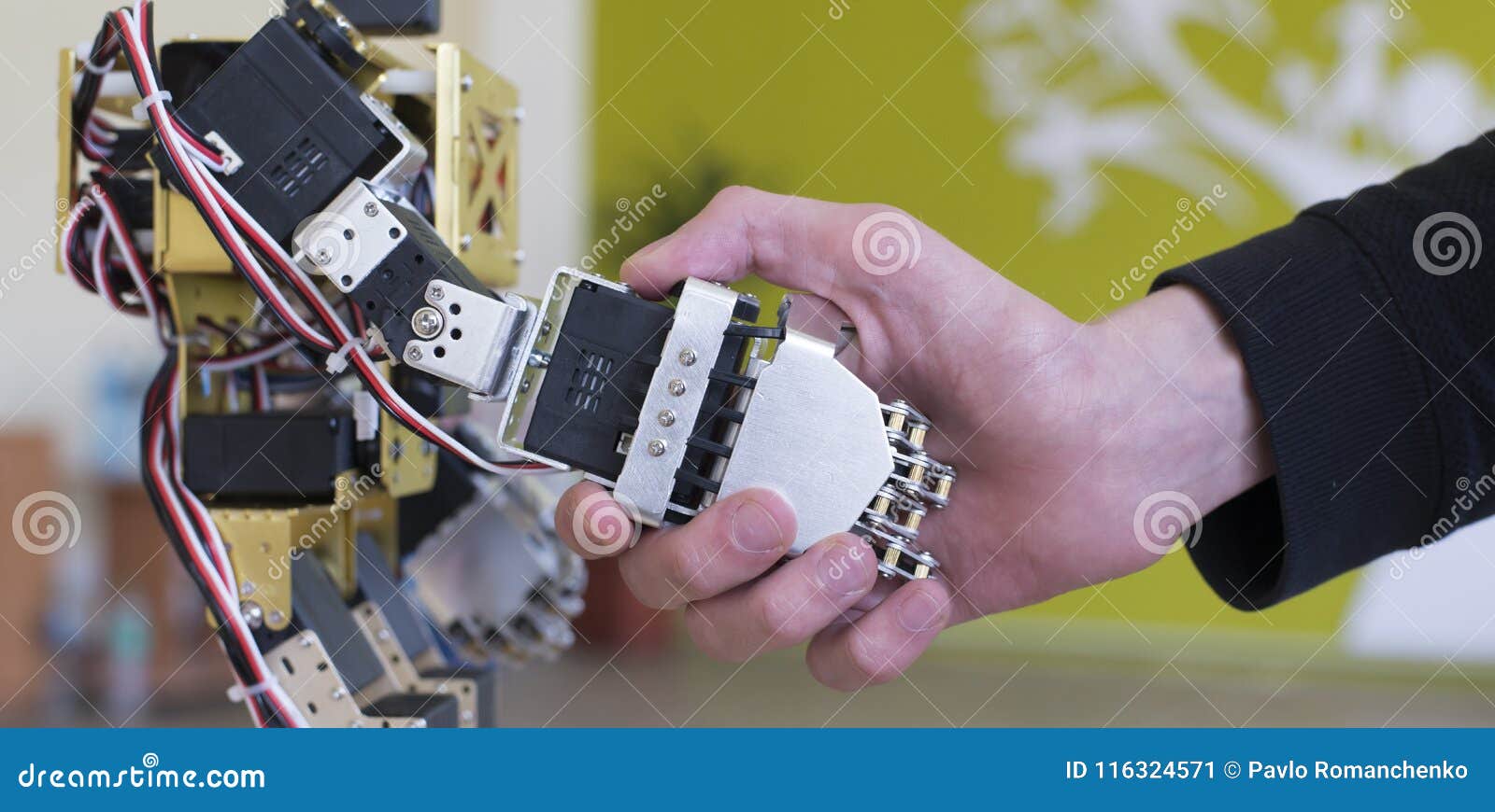 Human Hand Holding a Robot Hand with a Handshake Stock Image - Image of ...