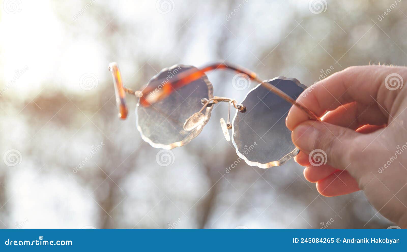 Human Hand Holding Sunglasses in Outdoors Stock Image - Image of light ...