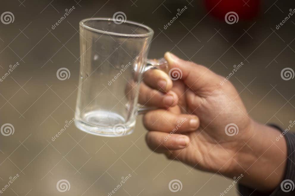 A Human Hand Holding a Tea Cup and the Background Blur Stock Image ...