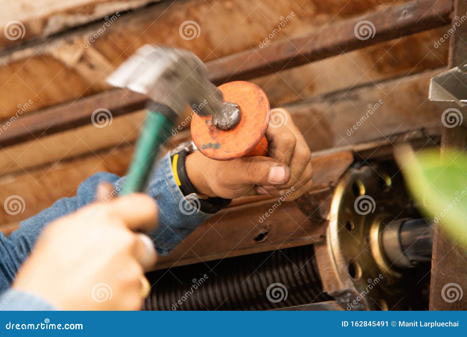 Human Hand Making Holes Using Hole Rolling Gate Puncher by Hammer ...