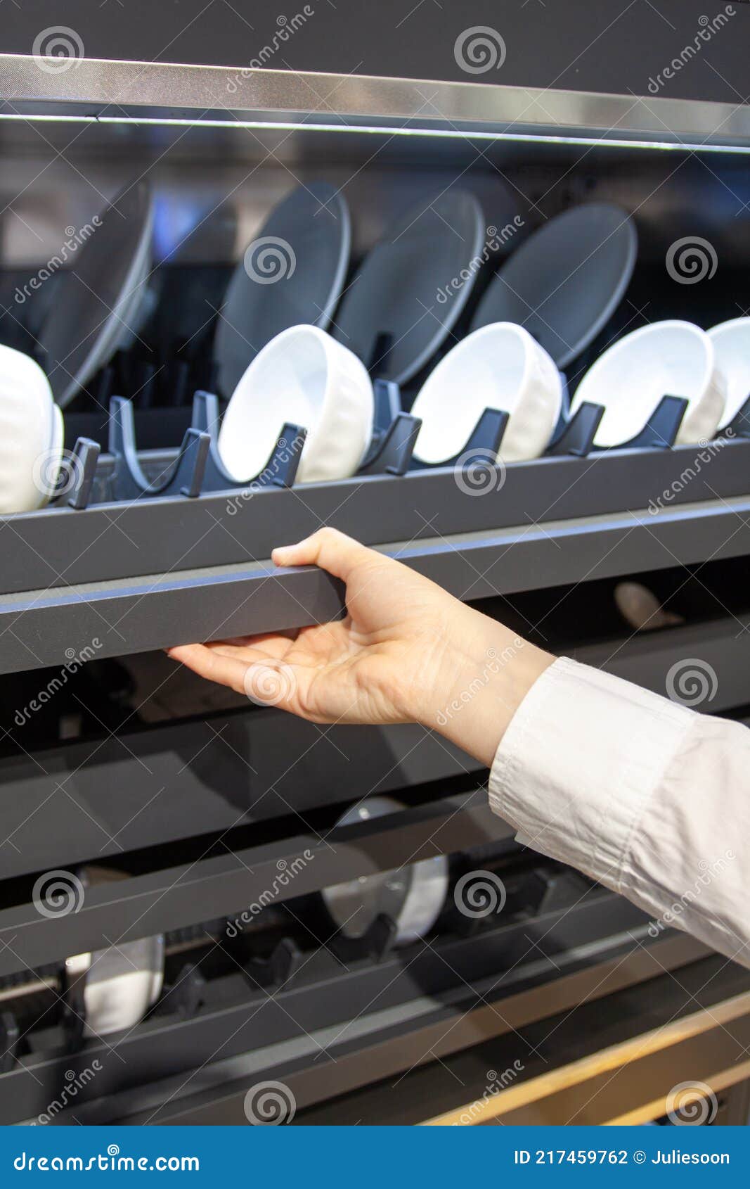 Human Hand Pulls Out a Contemporary Plastic Shelf with White Dishes ...