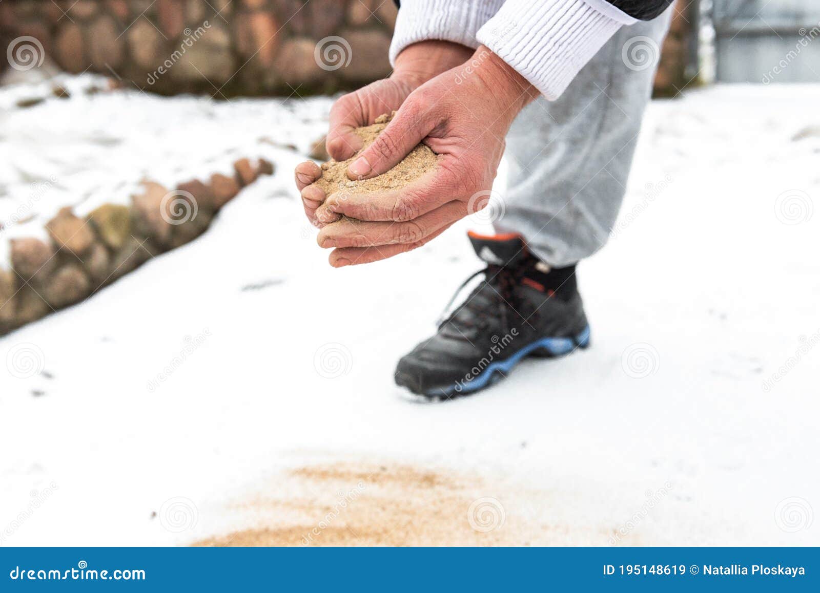 Human Hand Sprinkling Sand on Roads with Snow Stock Image - Image of ...
