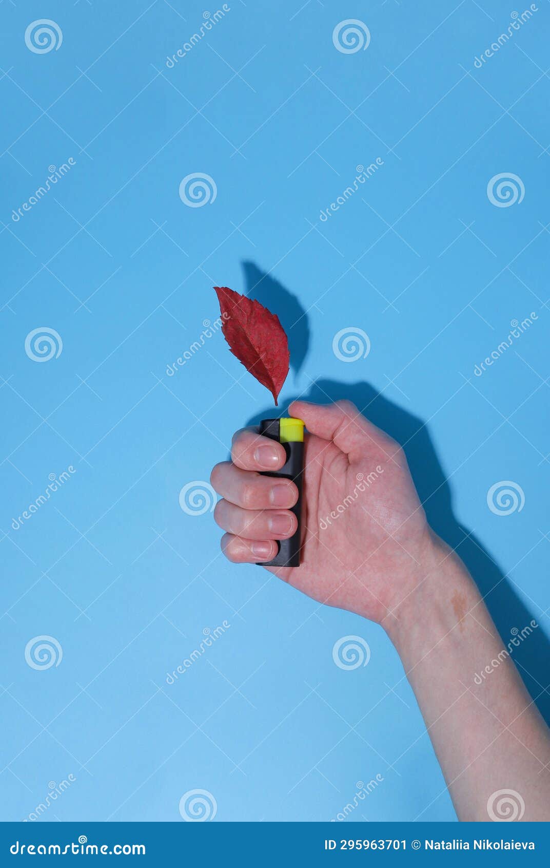 In a Human Hand There is a Black Lighter on a Blue Background. Ecology ...