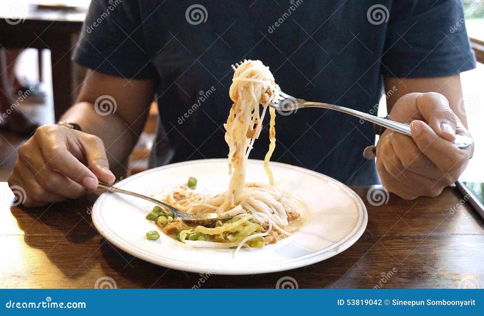 Human Hands Eating Asian Rice Noddle with Folk and Spoon Stock Photo ...