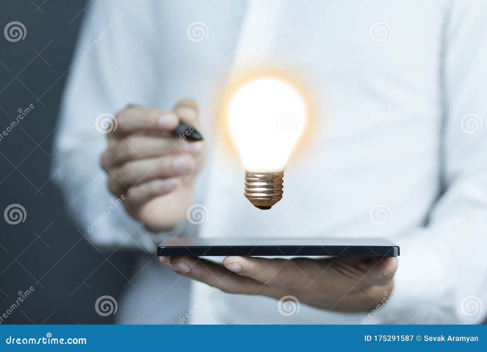 Human Hands Holding Tablet Pc with Light Bulb on it Stock Image - Image ...