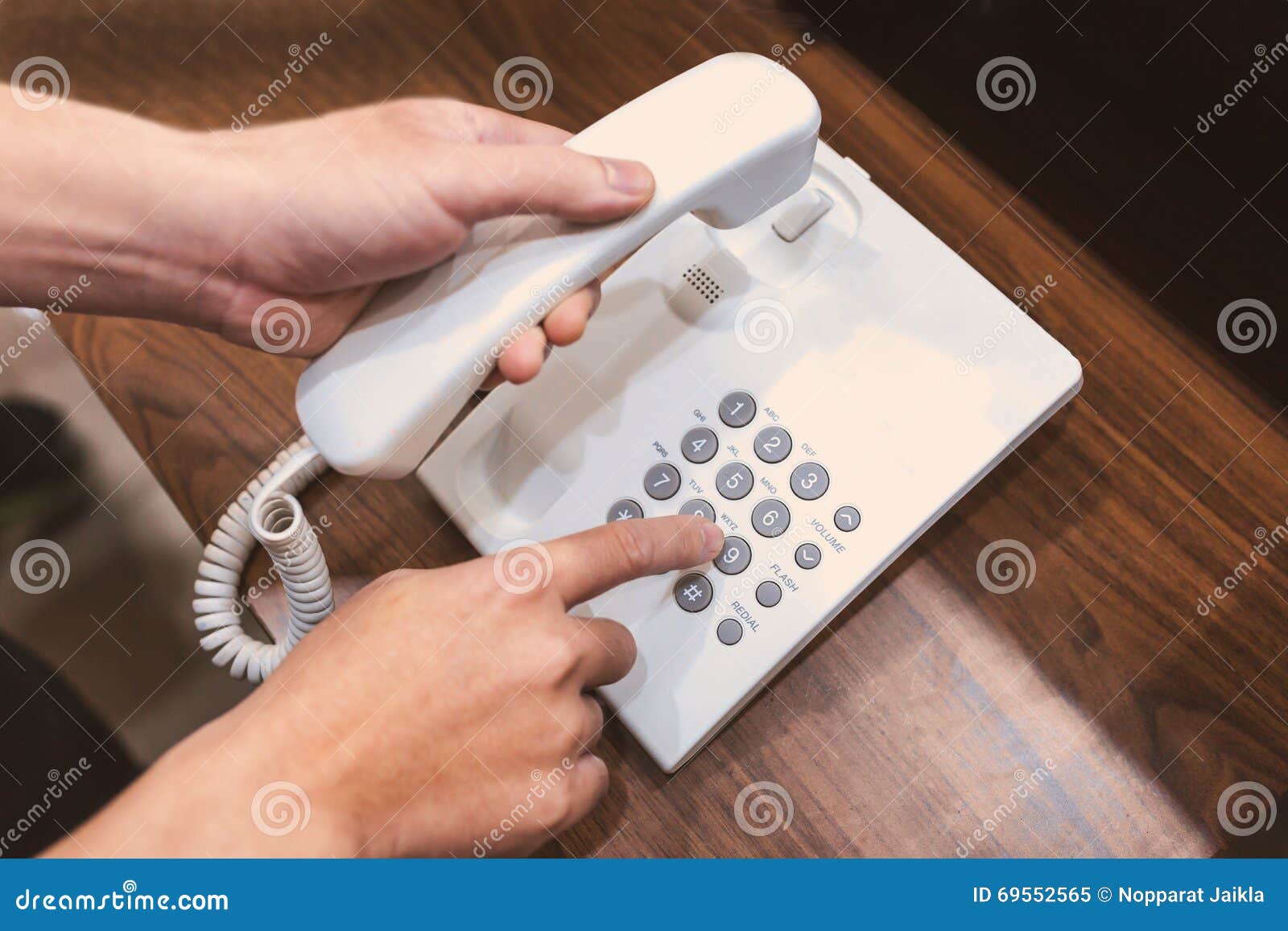 Human Hands Holding Telephone Handle and Dialing on Wooden Table Stock ...