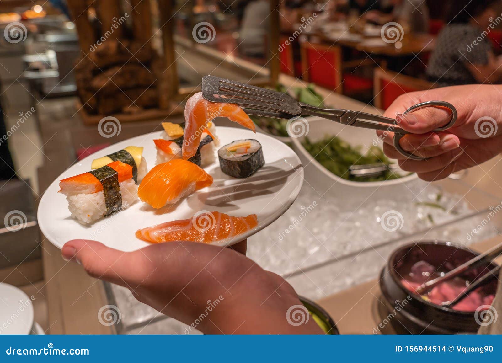 Human Picking Sashimi into His Plate in Luxury Buffet Restaurant Stock ...