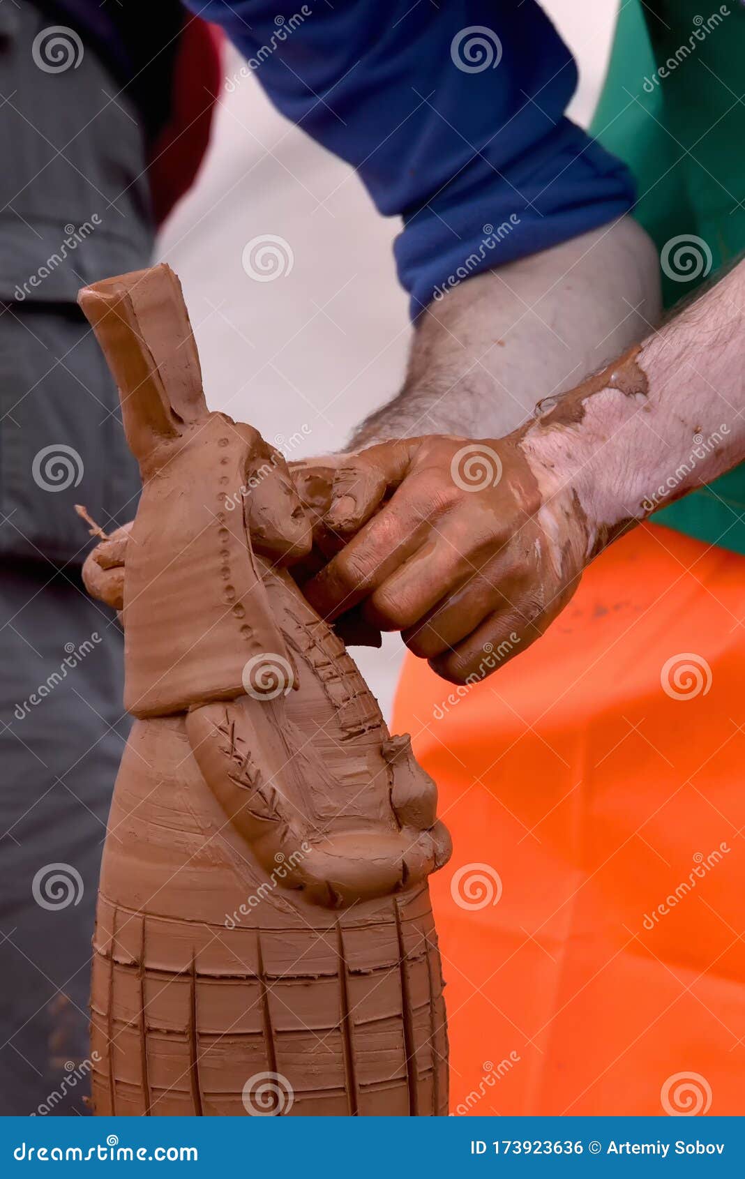 A Human Potter Works with Clay, Making a Ceramic Doll Out of Clay in a ...