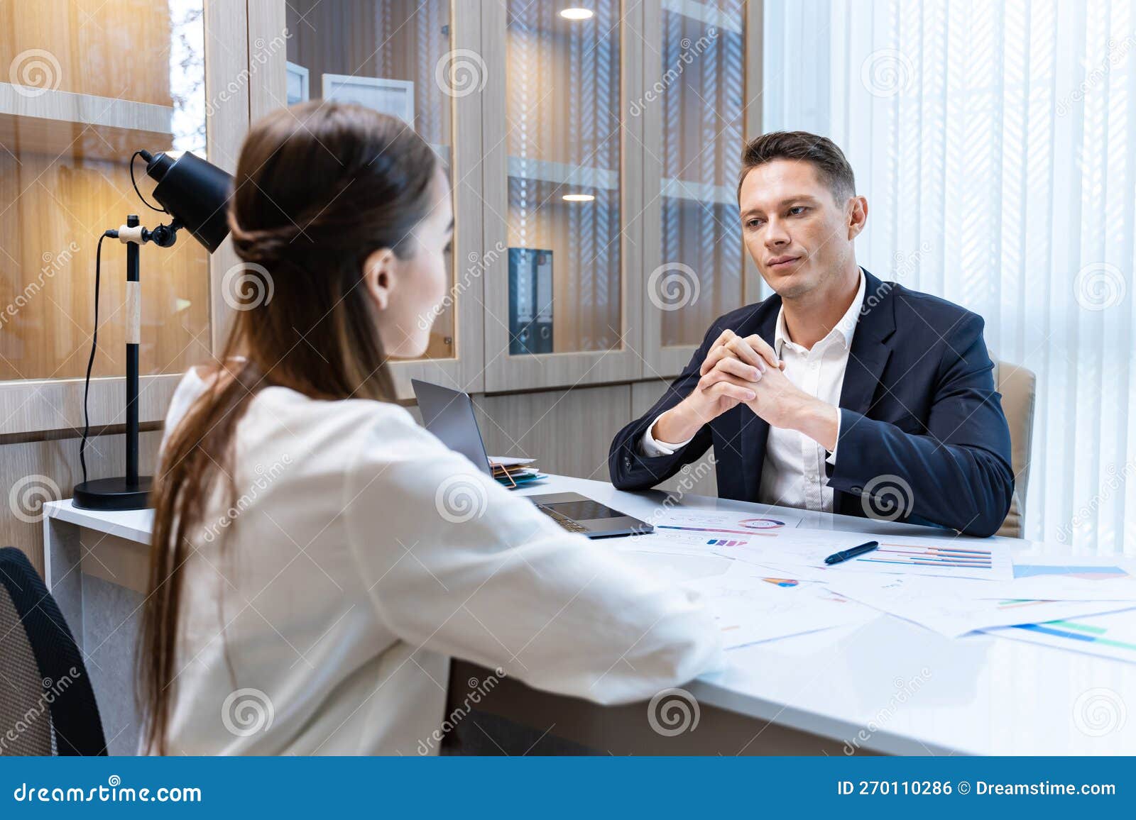 Human Resource Manager is Interviewing Young Applicant while Looking at ...