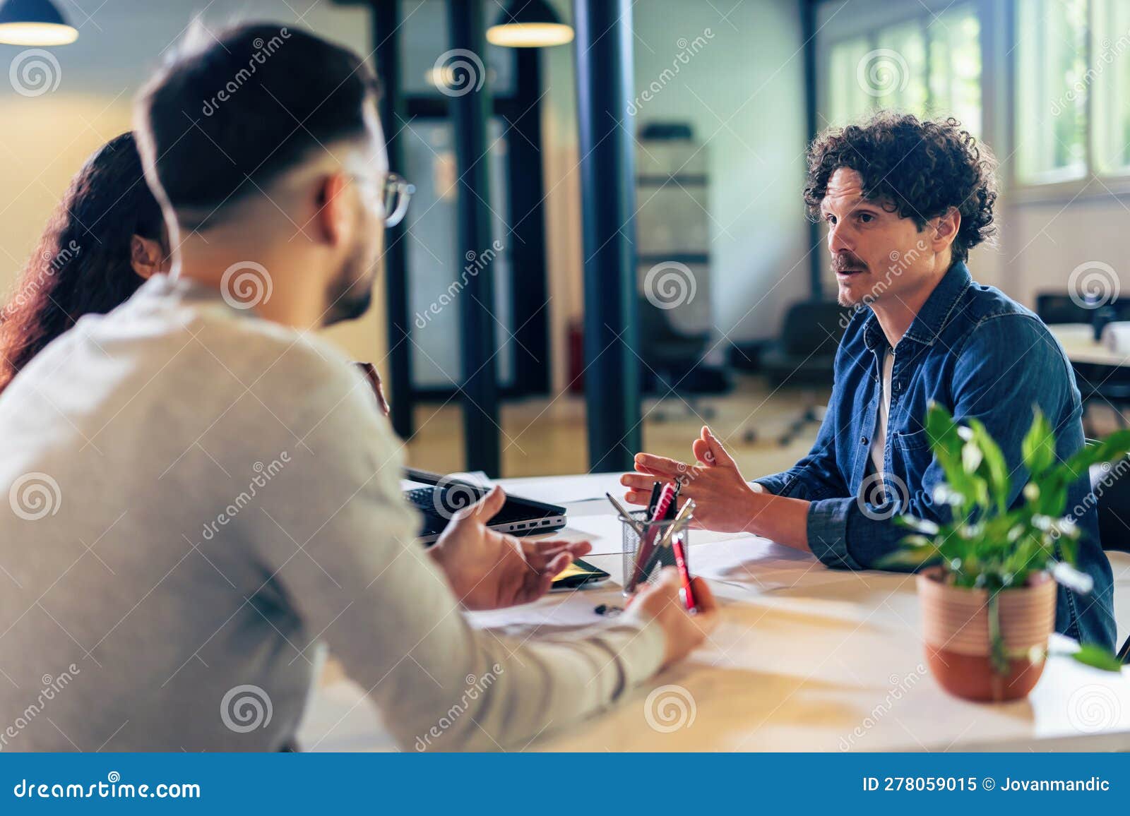 Human Resources Managers Conducting Job Interviews with Applicants in ...