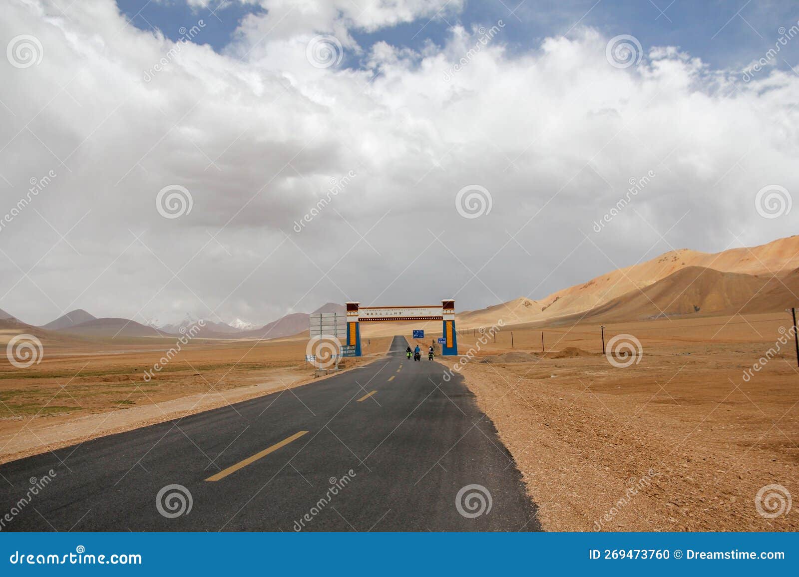 Human Riding Bicycle on Road through Desert Surrounded by Mountains ...