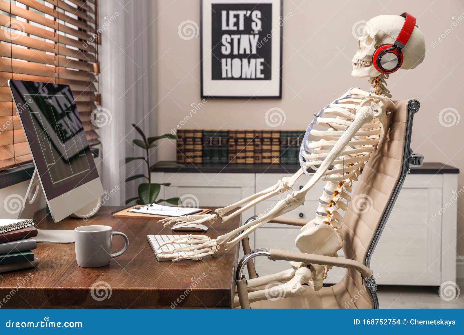 Human Skeleton with Headphones Using Computer Stock Photo - Image of ...