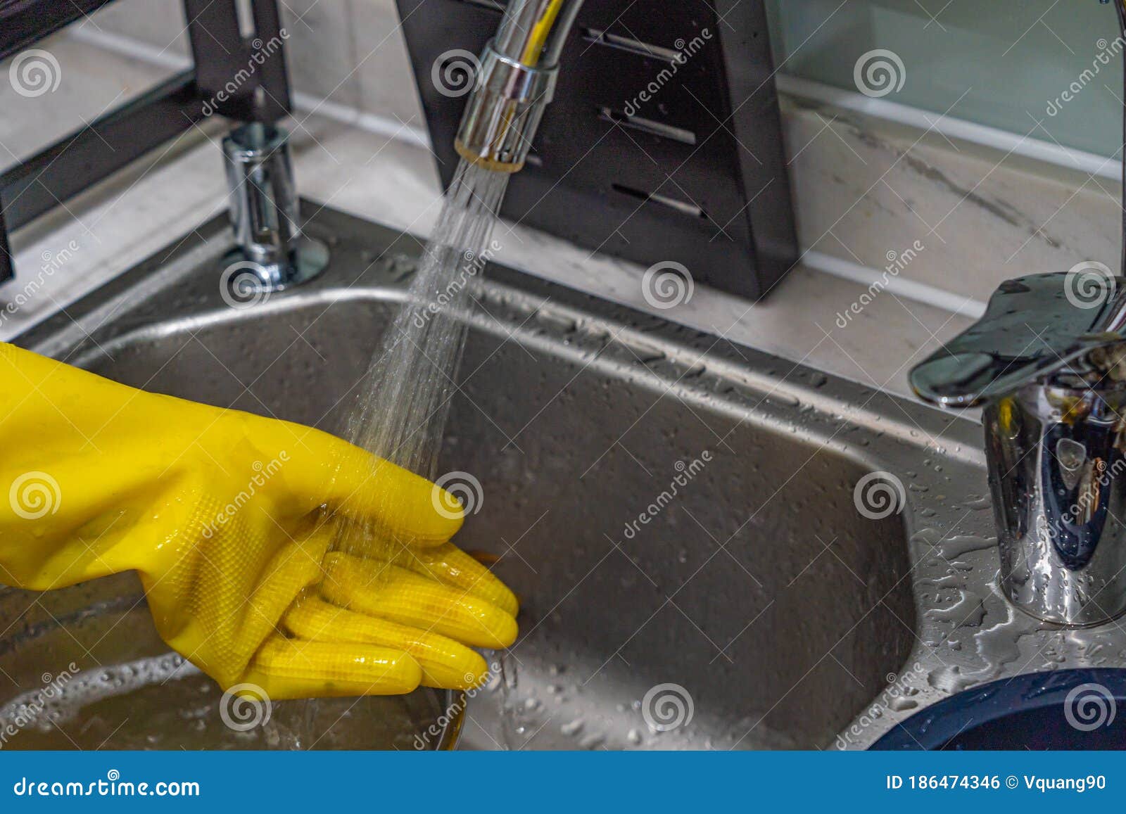 Human Wearing Plastic Gloves And Rinsing Water At The Sink Stock Photo ...