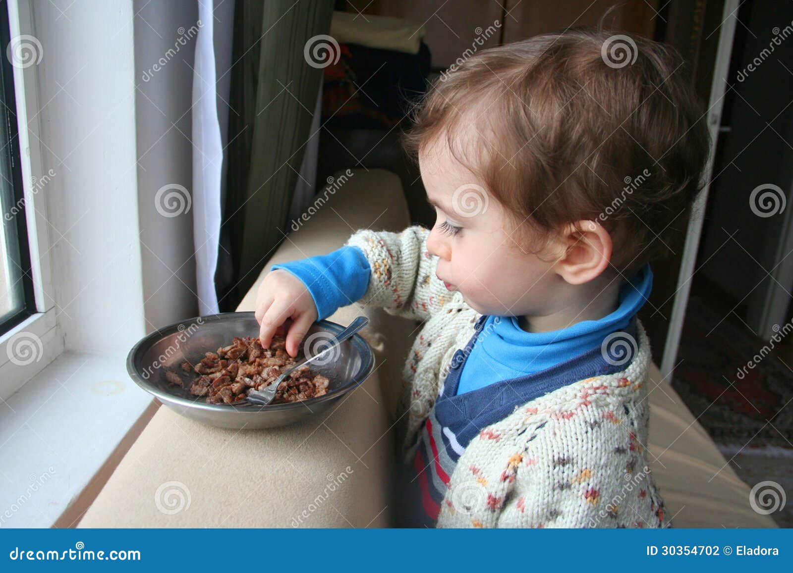 Hungry child eating meat stock photo. Image of child - 30354702