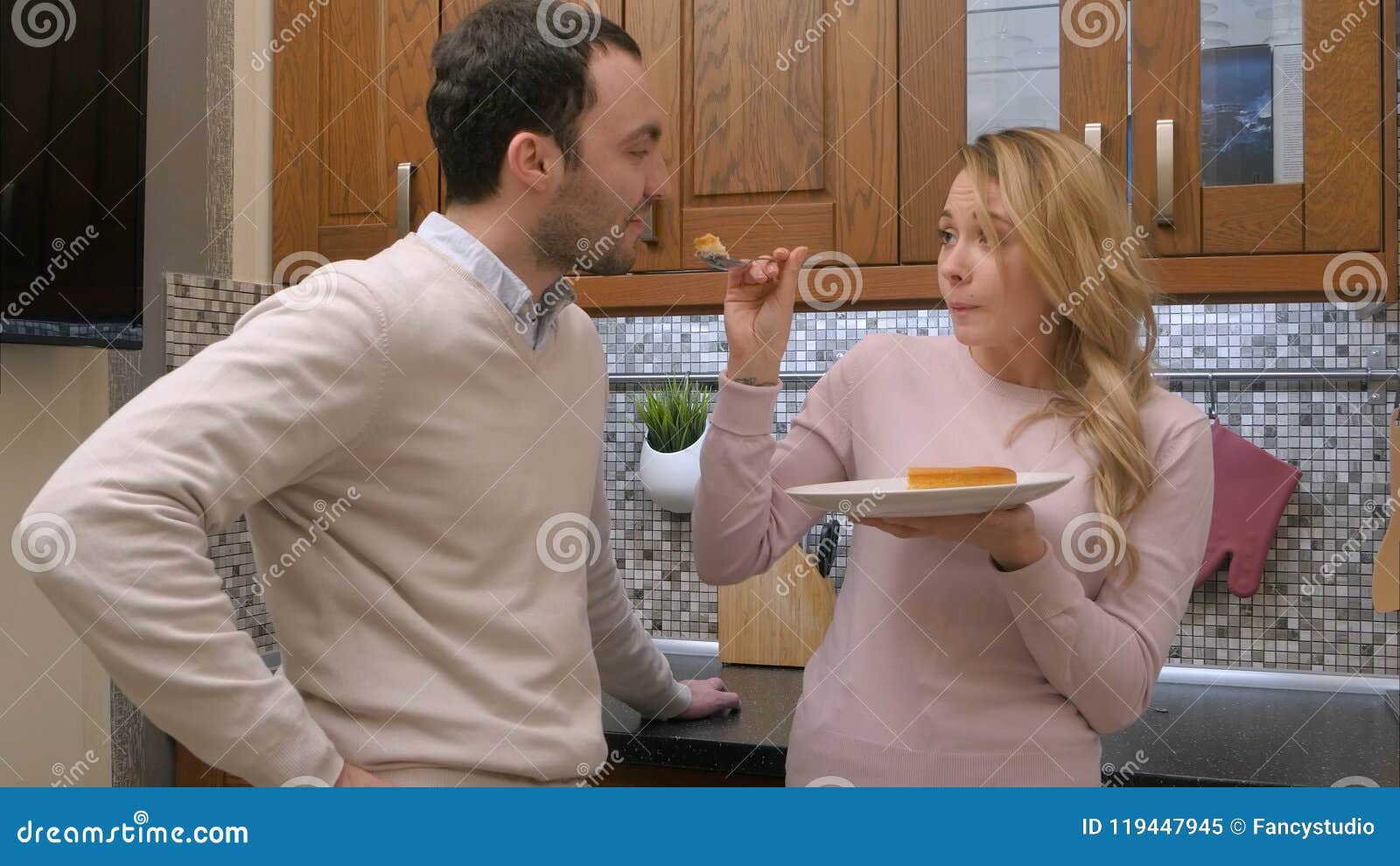 Hungry Couple Eating Delicious Cake Woman Feeding Man In The Kitchen