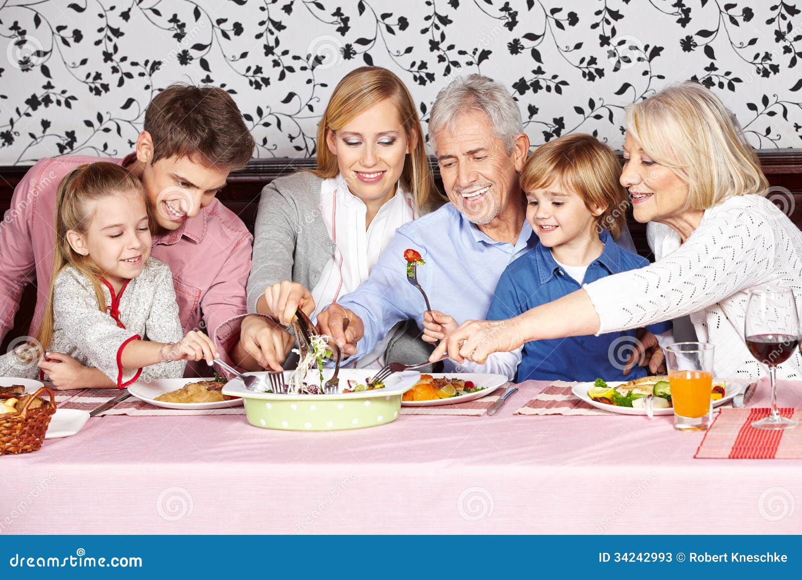 Hungry Family Reaching For Food At Stock Photos - Image: 34242993