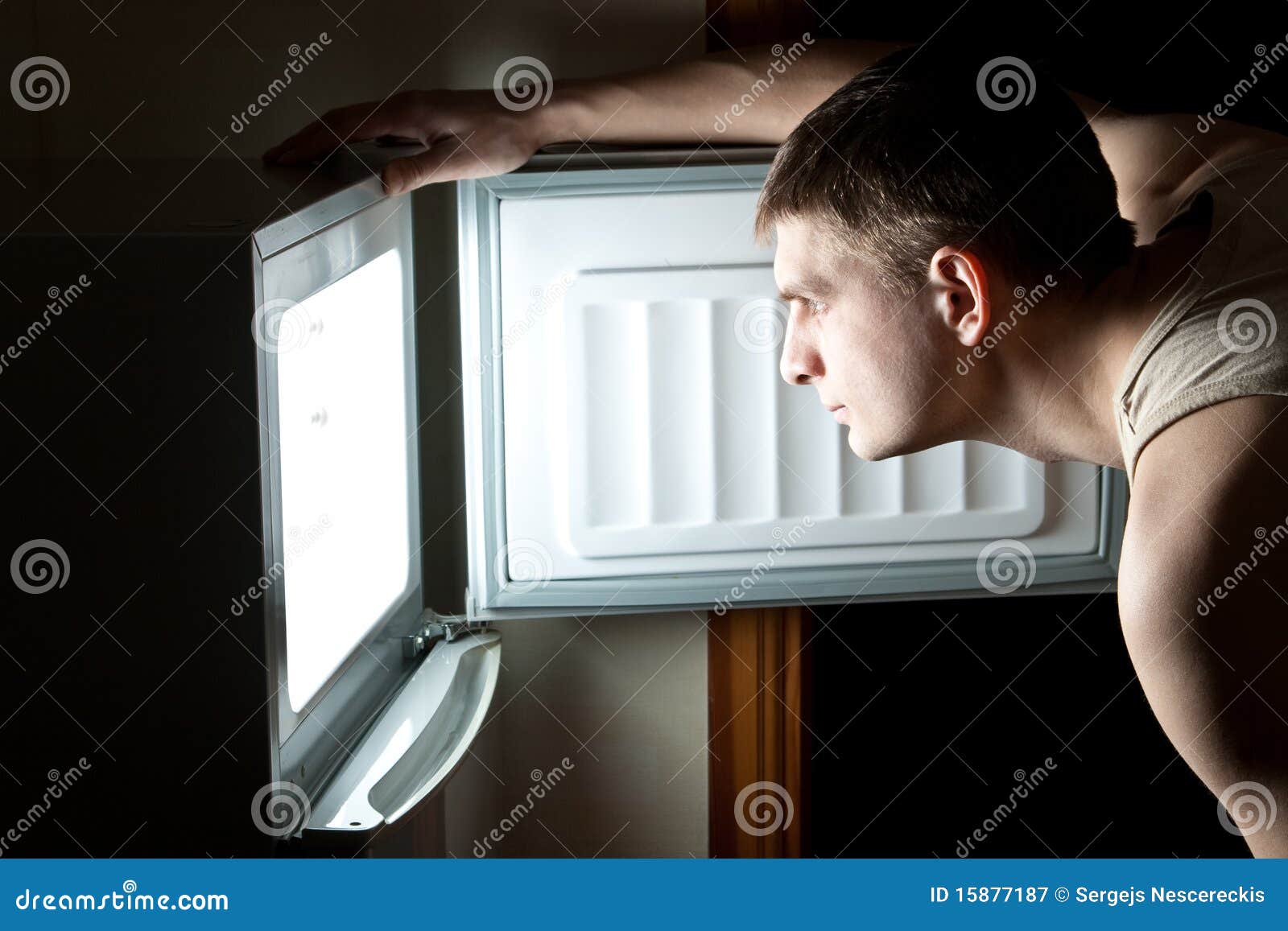 Hungry man opening fridge. stock image. Image of kitchen - 15877187