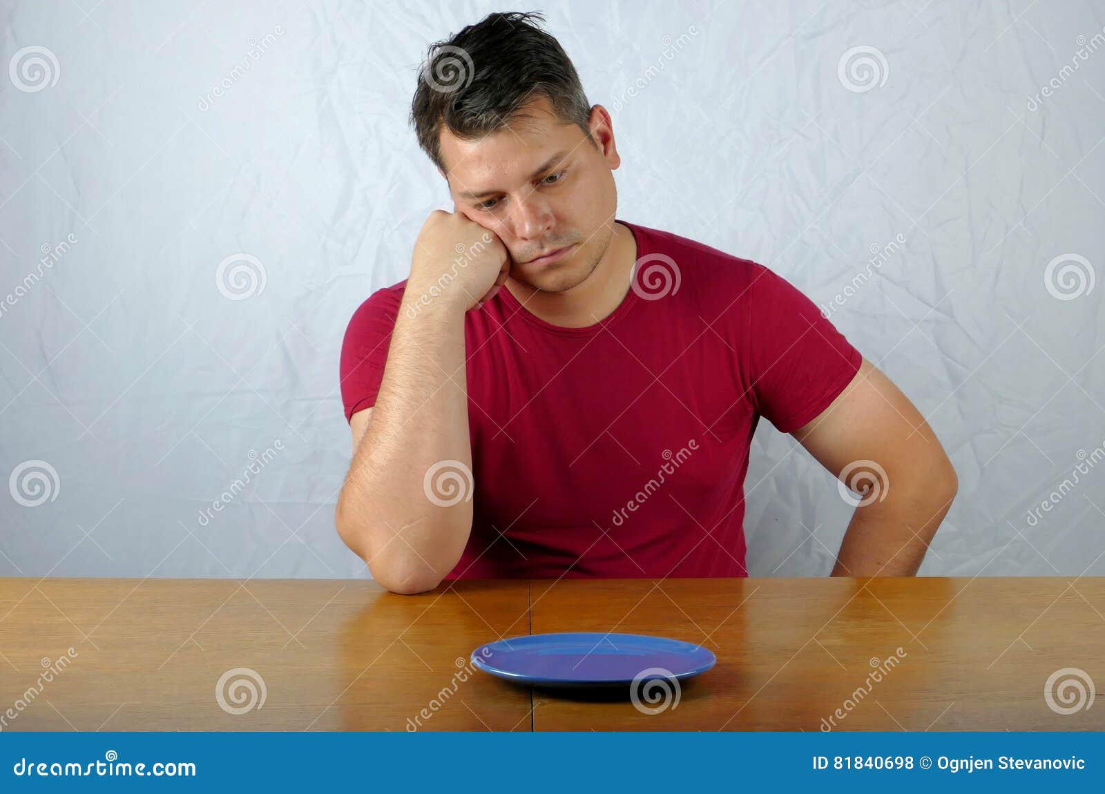 Hungry man watching plate stock photo. Image of face - 81840698