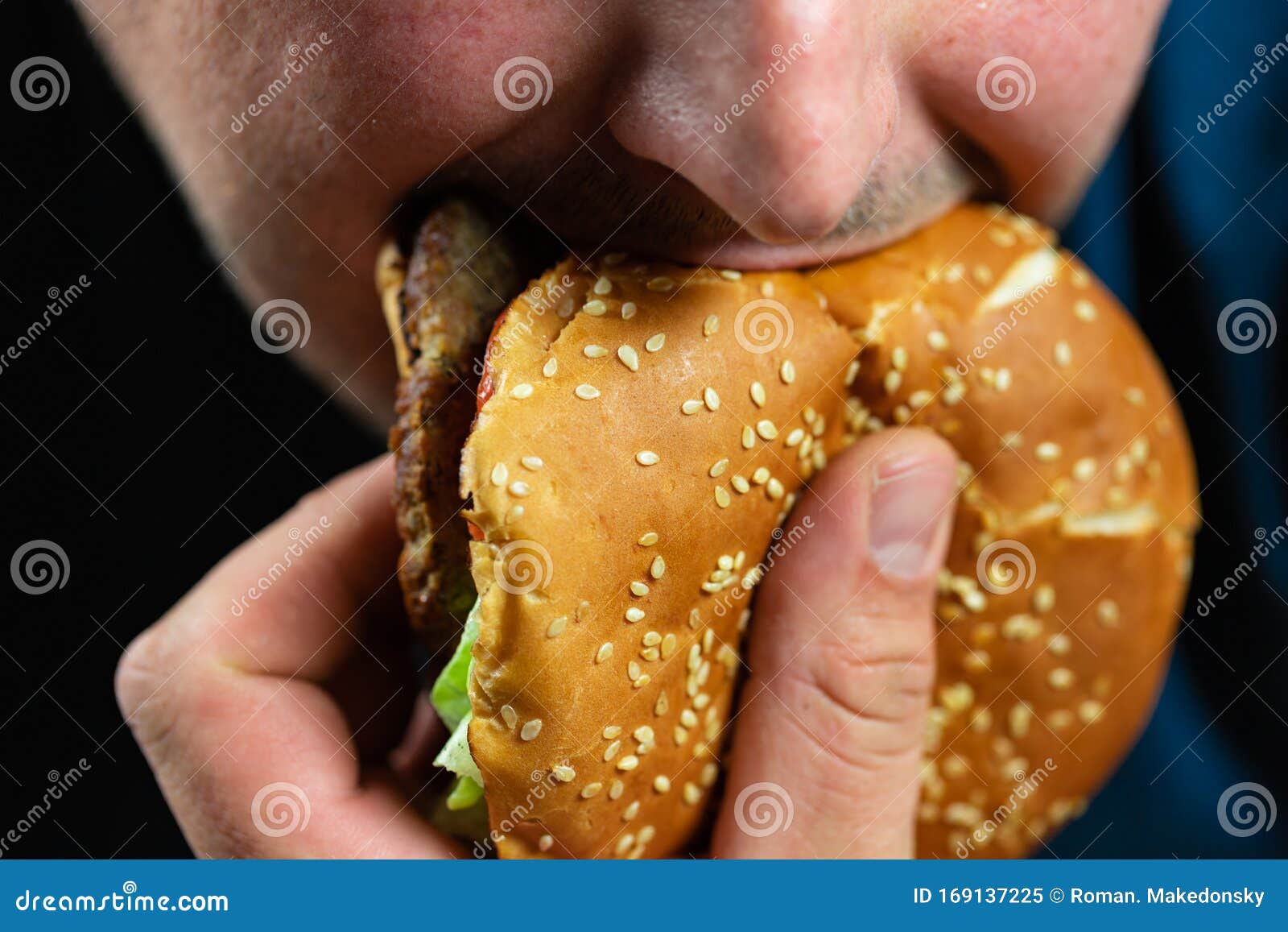 The Hungry Young Man Aggressively Eats a Burger. Fast Food Stock Image ...