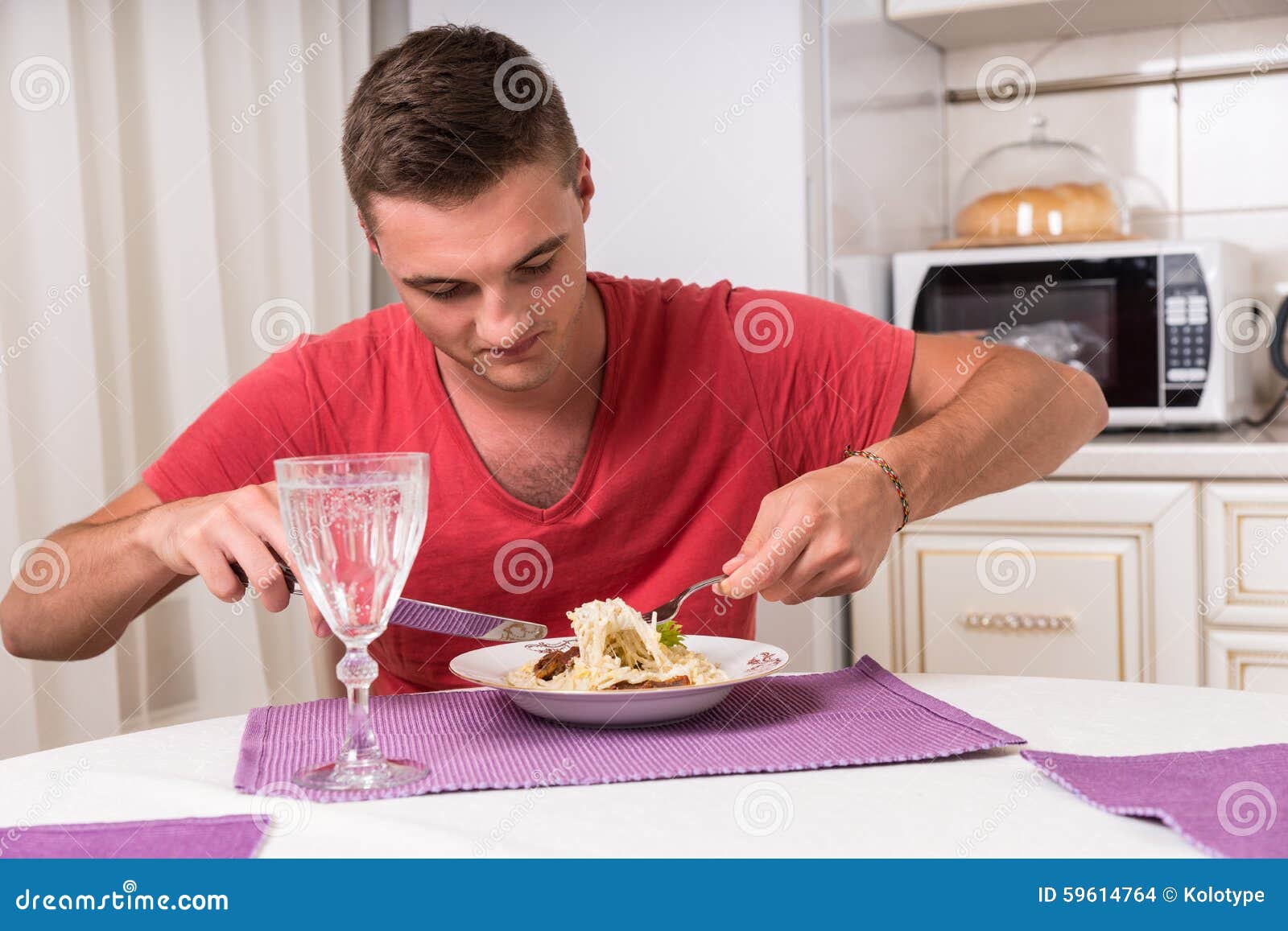 Hungry Young Man Eating Pasta at Dining Table Stock Photo - Image of ...