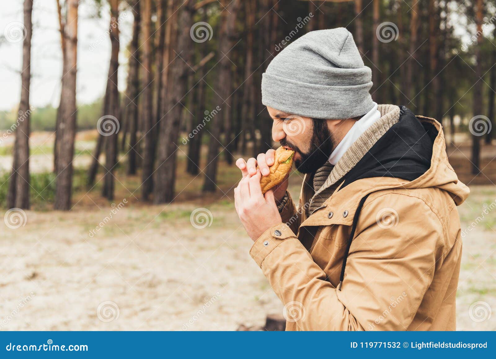 Hungry young man eating stock photo. Image of caucasian - 119771532