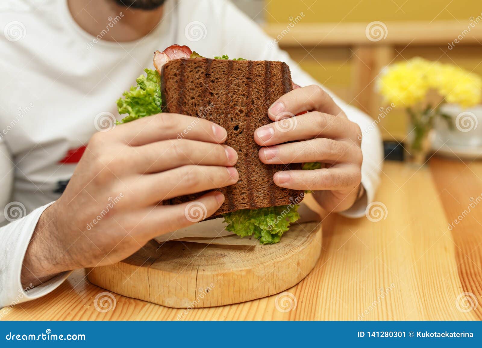 Hungry Young Man in Restaurant Eat Sandwich. Stock Image - Image of ...