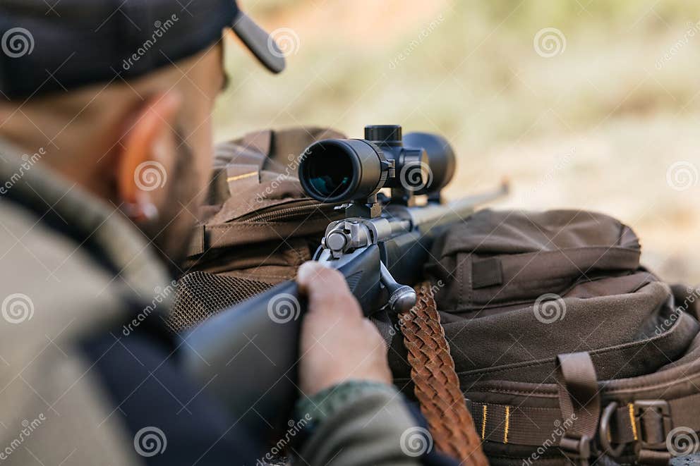 Hunter Aiming with Rifle Scope in Wilderness Setting Stock Image ...