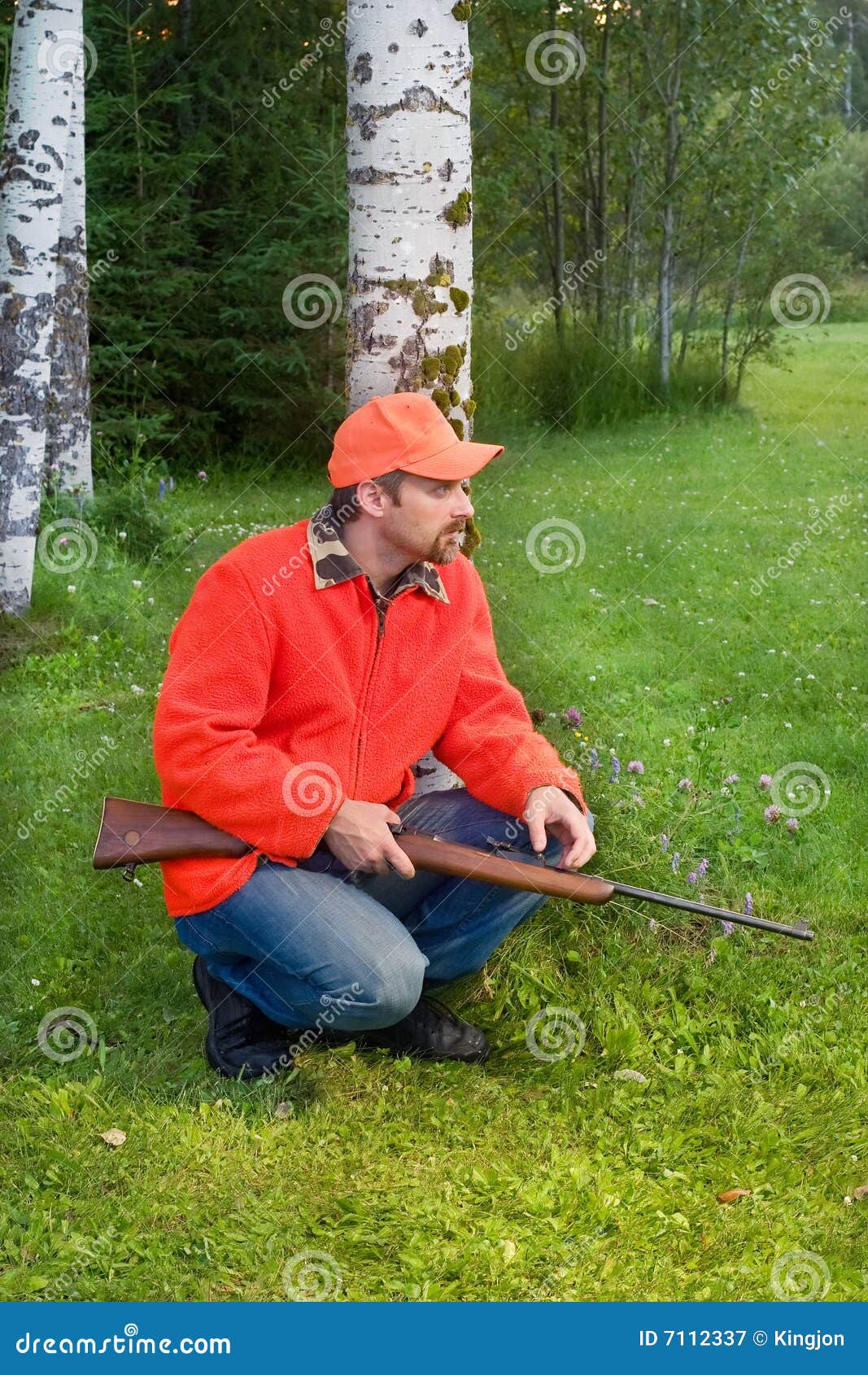 Hunter crouching stock image. Image of jacket, orange - 7112337