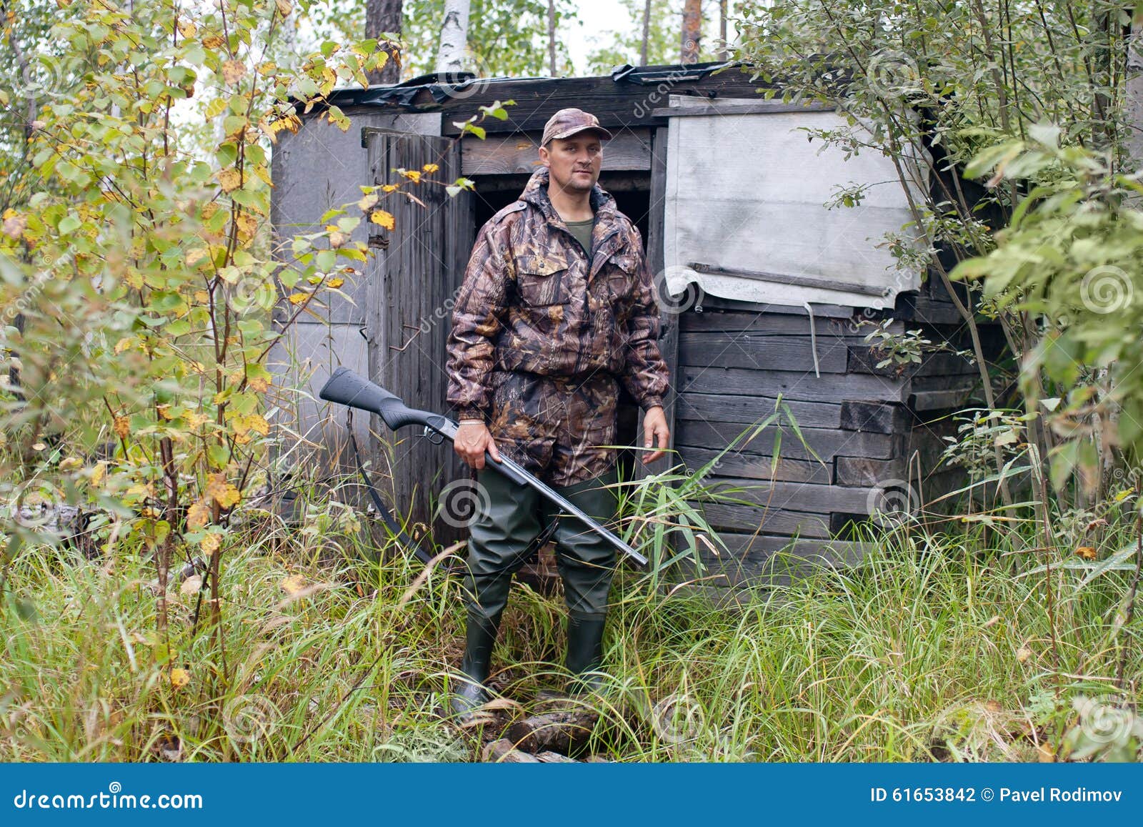 Hunter at the forest hut stock photo. Image of rural - 61653842
