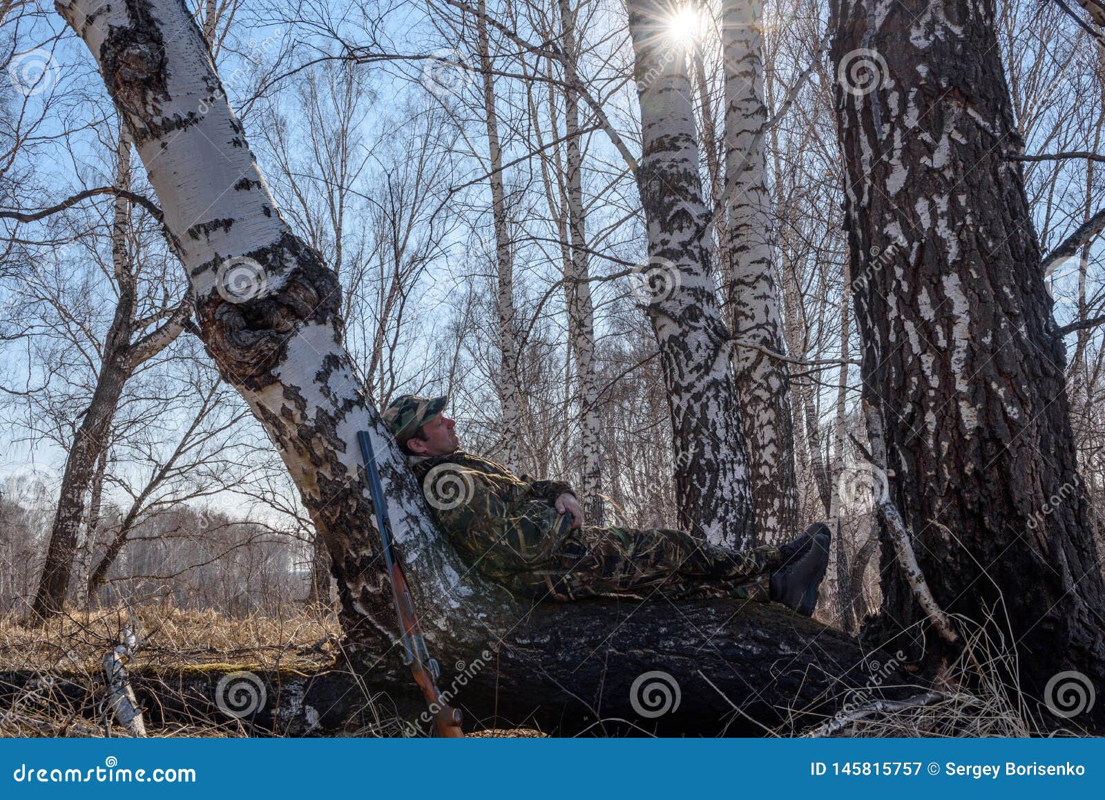 The Hunter is Resting on a Tree Trunk. Stock Image - Image of road ...