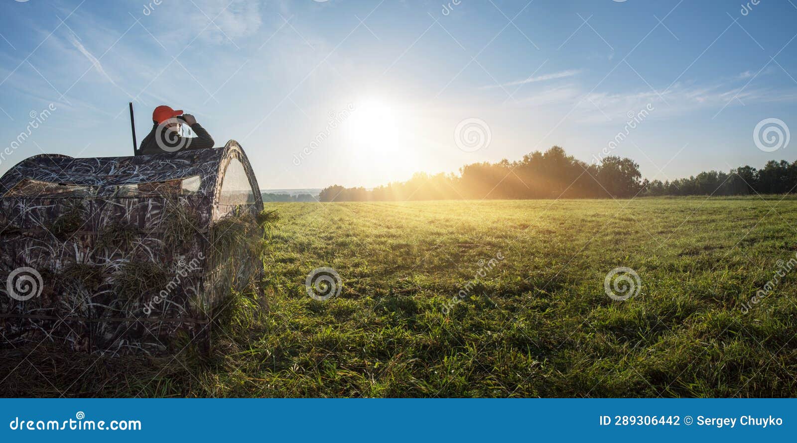 Hunter Looking through Binoculars. Hunter Man in Hunting Blind Stock ...