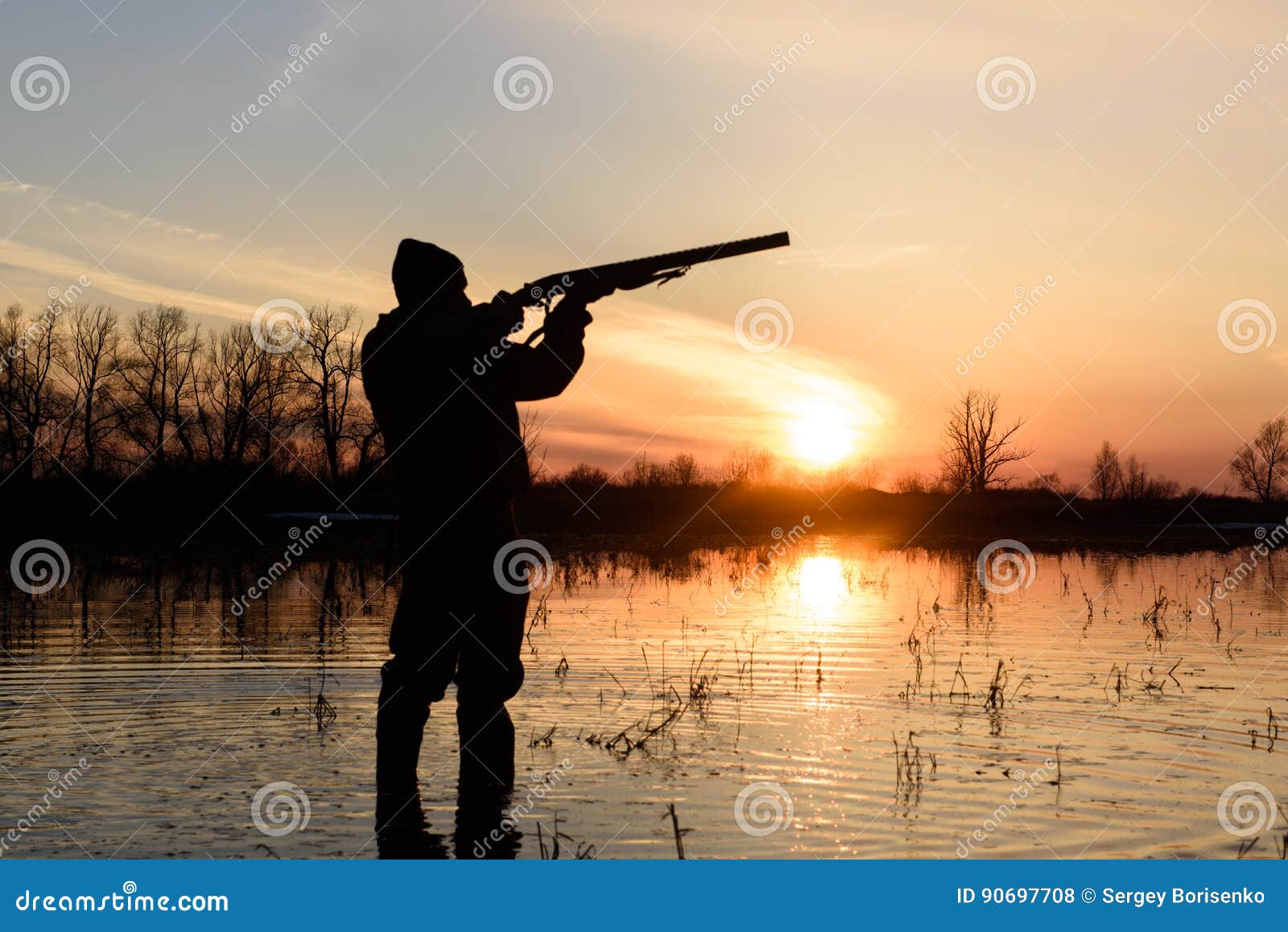 Hunter at sunset. stock photo. Image of bushes, shot - 90697708