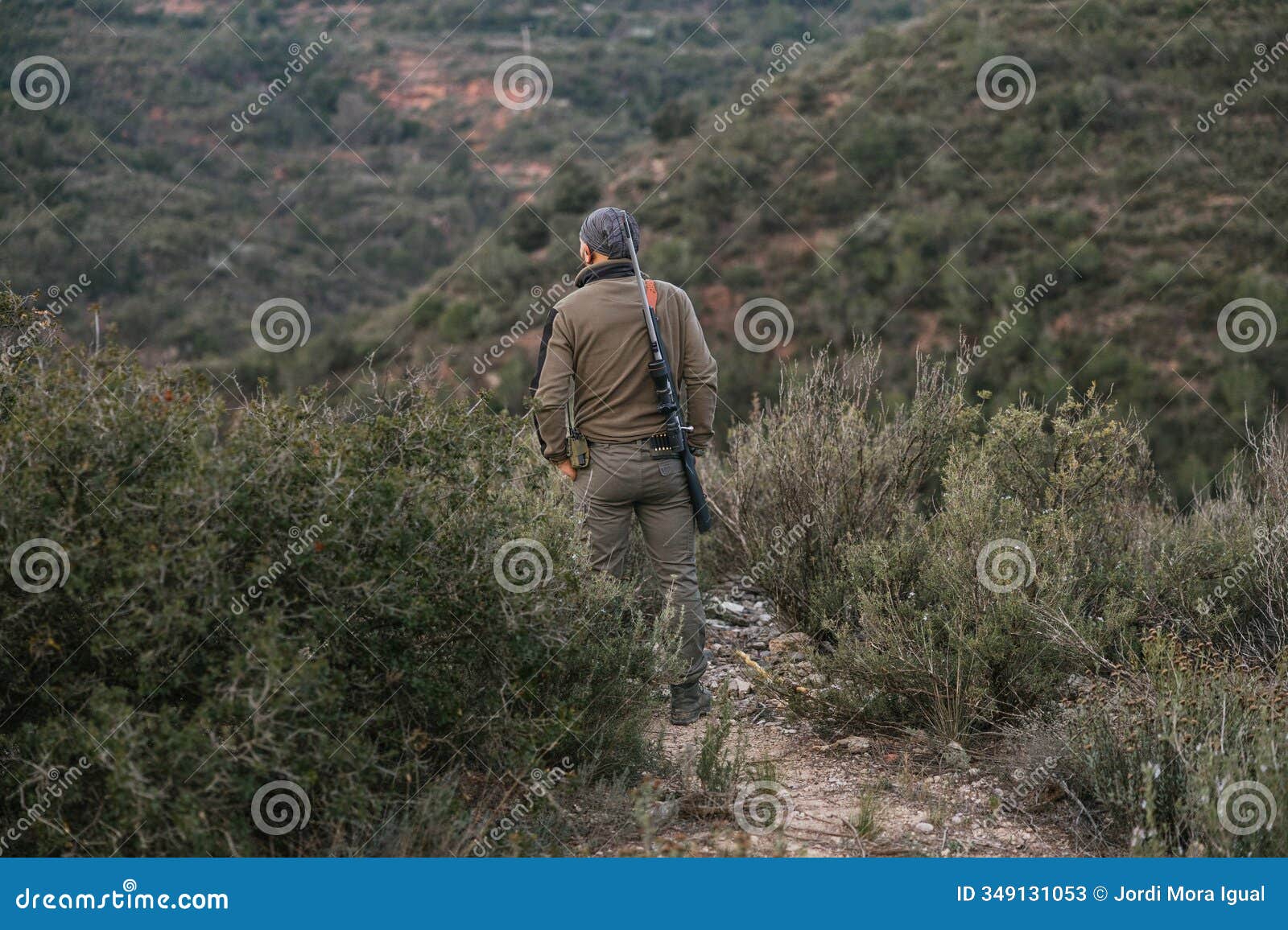 Hunter Walking on Dirt Path Carrying Rifle on His Shoulder Stock Image ...