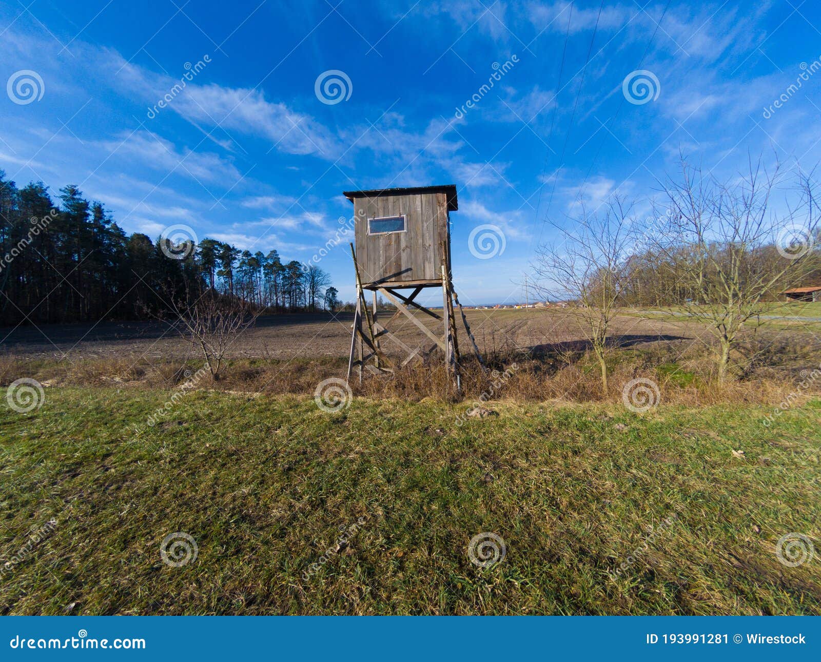 Hunting Tower Standing in a Field with a Blue Cloudy Sky Above Stock ...