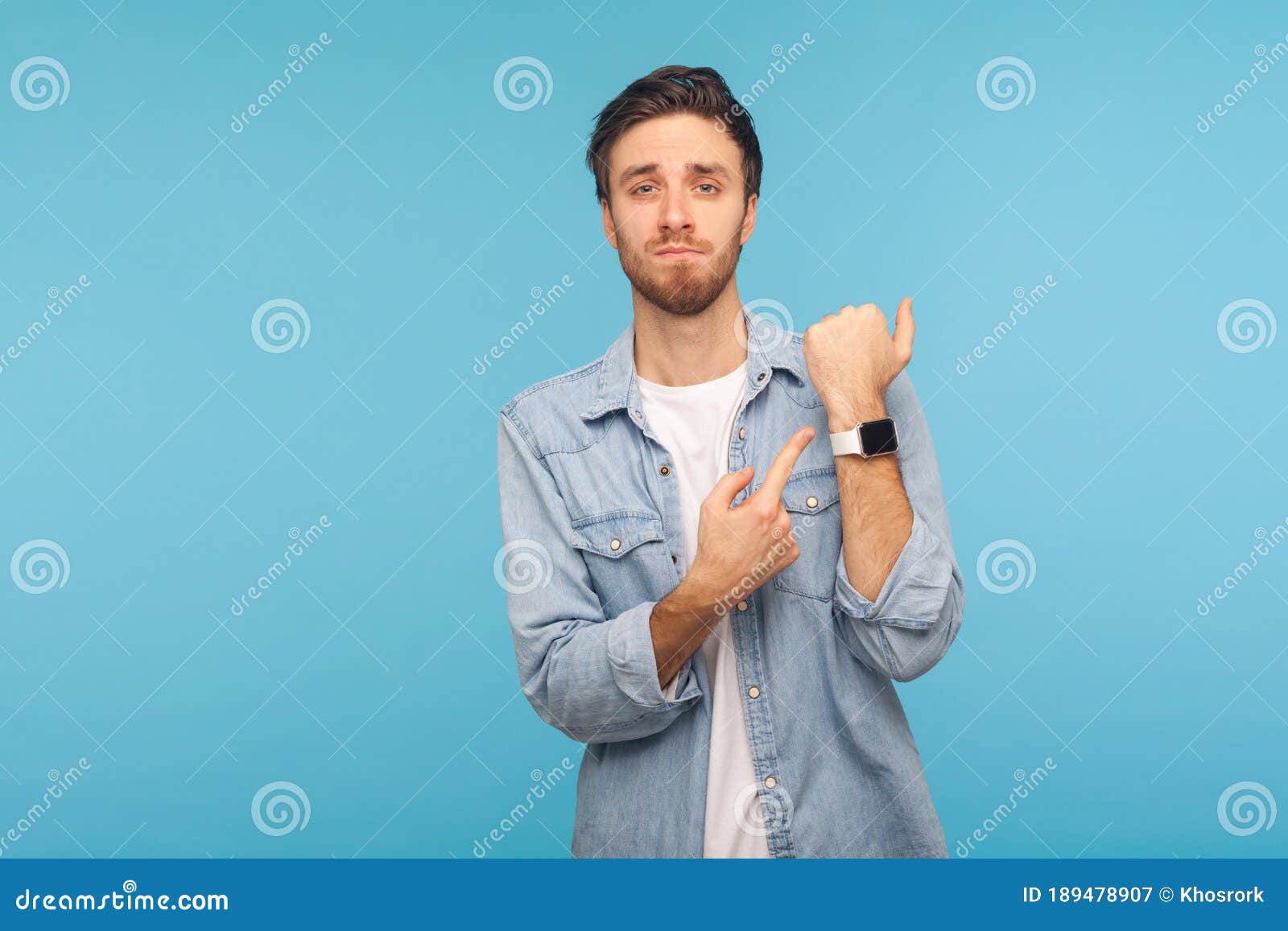 Hurry Up! Portrait of Punctual Man in Denim Shirt Pointing at Wrist ... Hurry Up! Portrait of Punctual Man in Denim Shirt Pointing at Wrist ...
