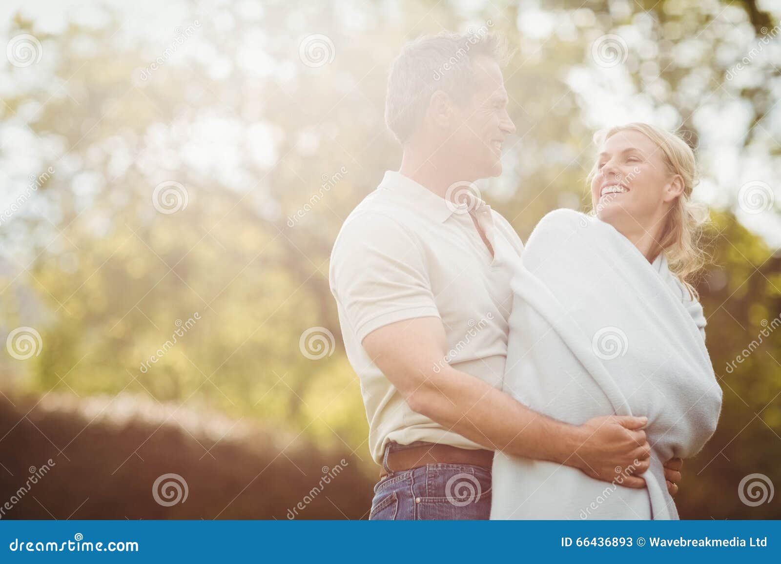 Husband Hugging His Wife in a Blanket Stock Image - Image of green ...