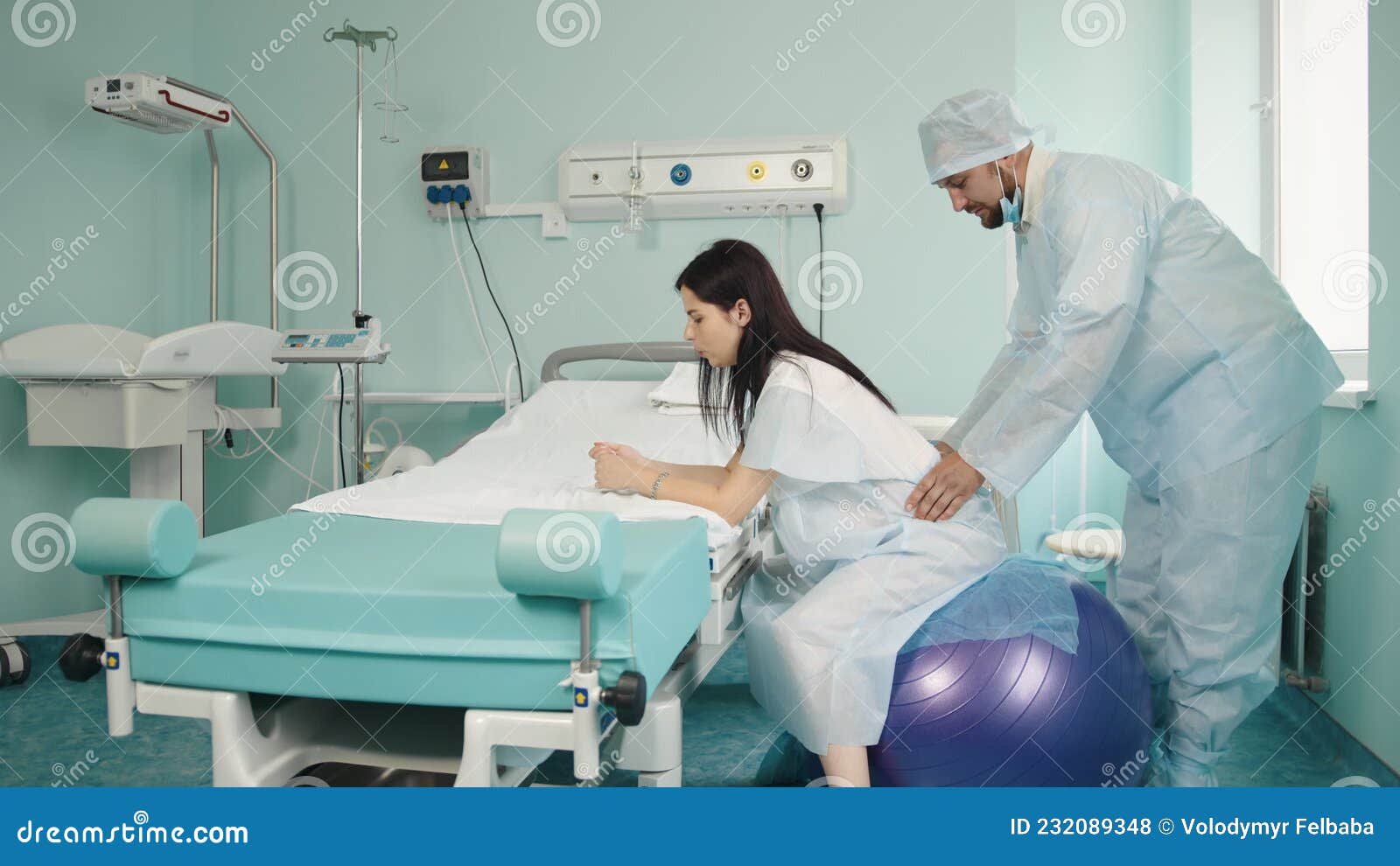 Husband Massaging Back Of Pregnant Wife During Contractions Stock