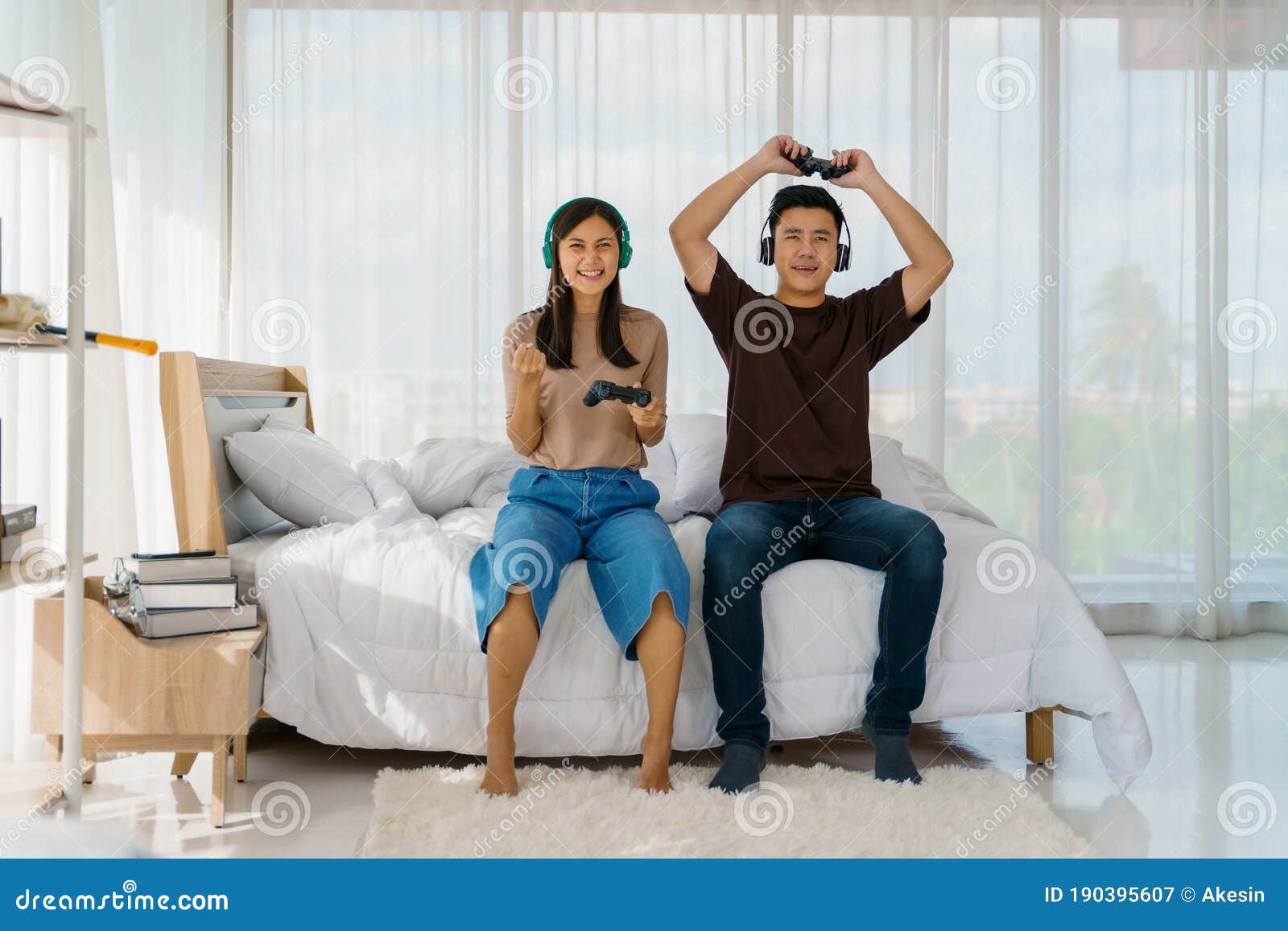 Husband And Wife Couple Have Fun Play Video Game Together At Home Stock
