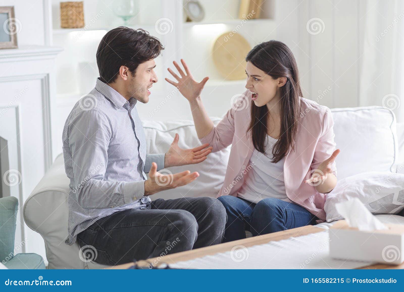Husband And Wife Having Fight In Therapy Or Marital Counseling Stock