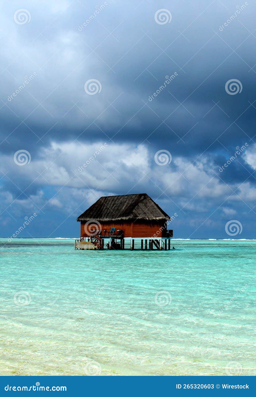 Hut on a Beach in the Maldives Surrounded by the Bright Blue Waters of ...