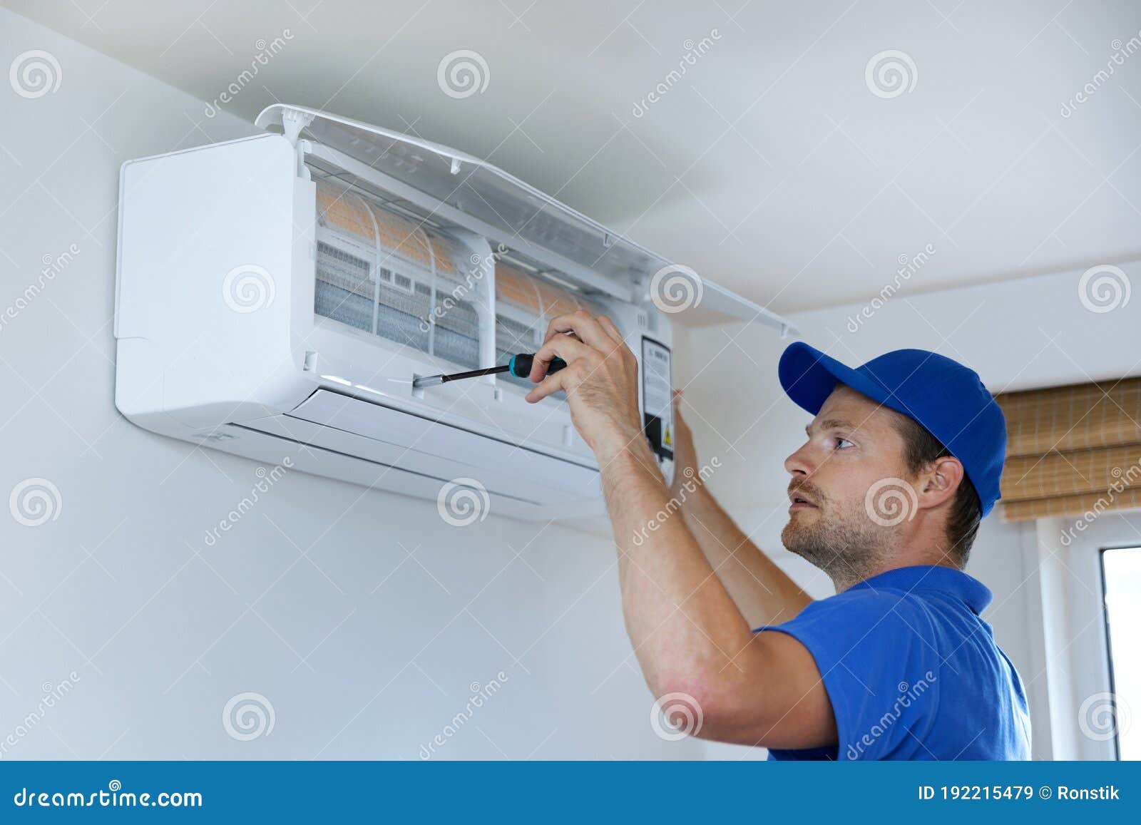 Technician Installing Indoor Air Conditioner Condenser Unit On Wall ...