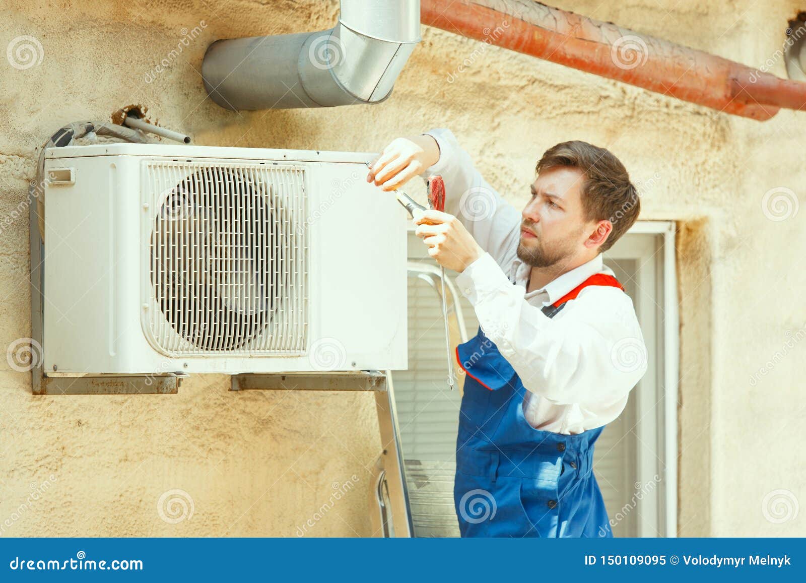 HVAC Technician Working on a Capacitor Part for Condensing Unit Stock ...