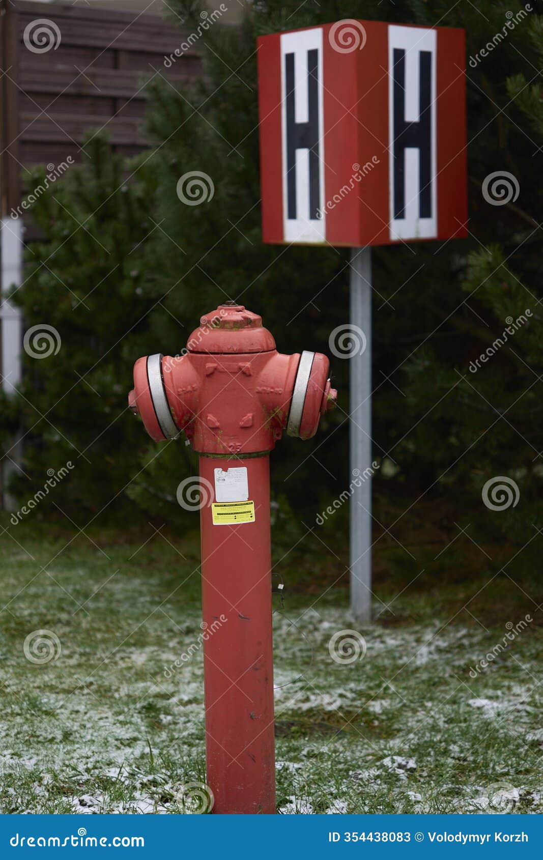 The Hydrant Marker and Fire Hydrant are Both Located within a Lush Area ...